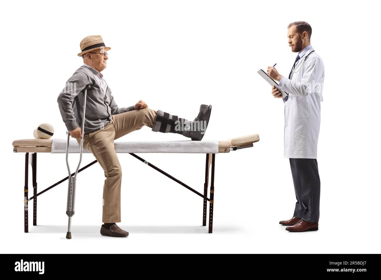 Doctor writing a prescription and an elderly male patient sitting on a ...