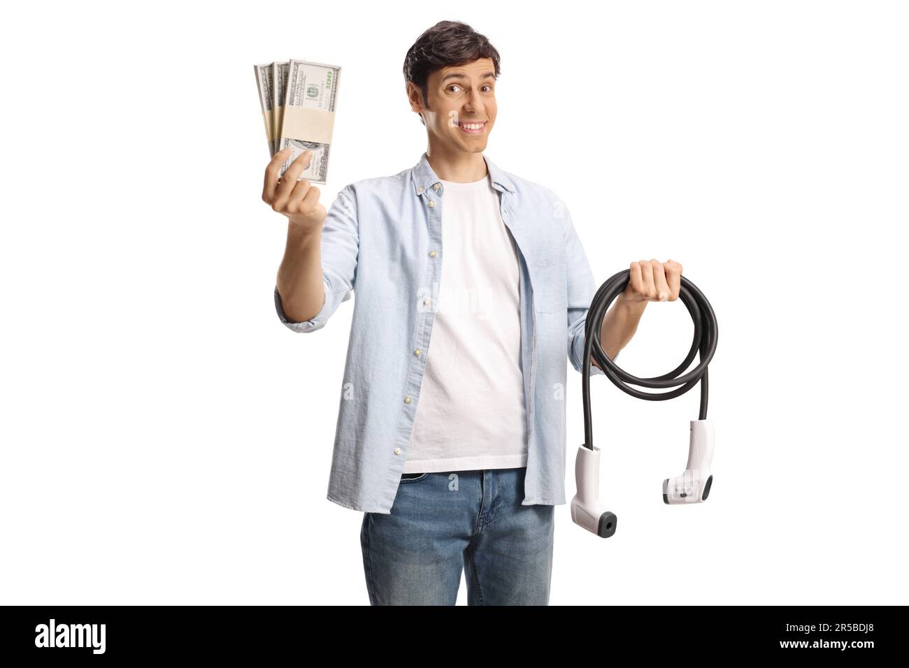 Man holding a cable for electrical vehicle charging and stacks of money ...