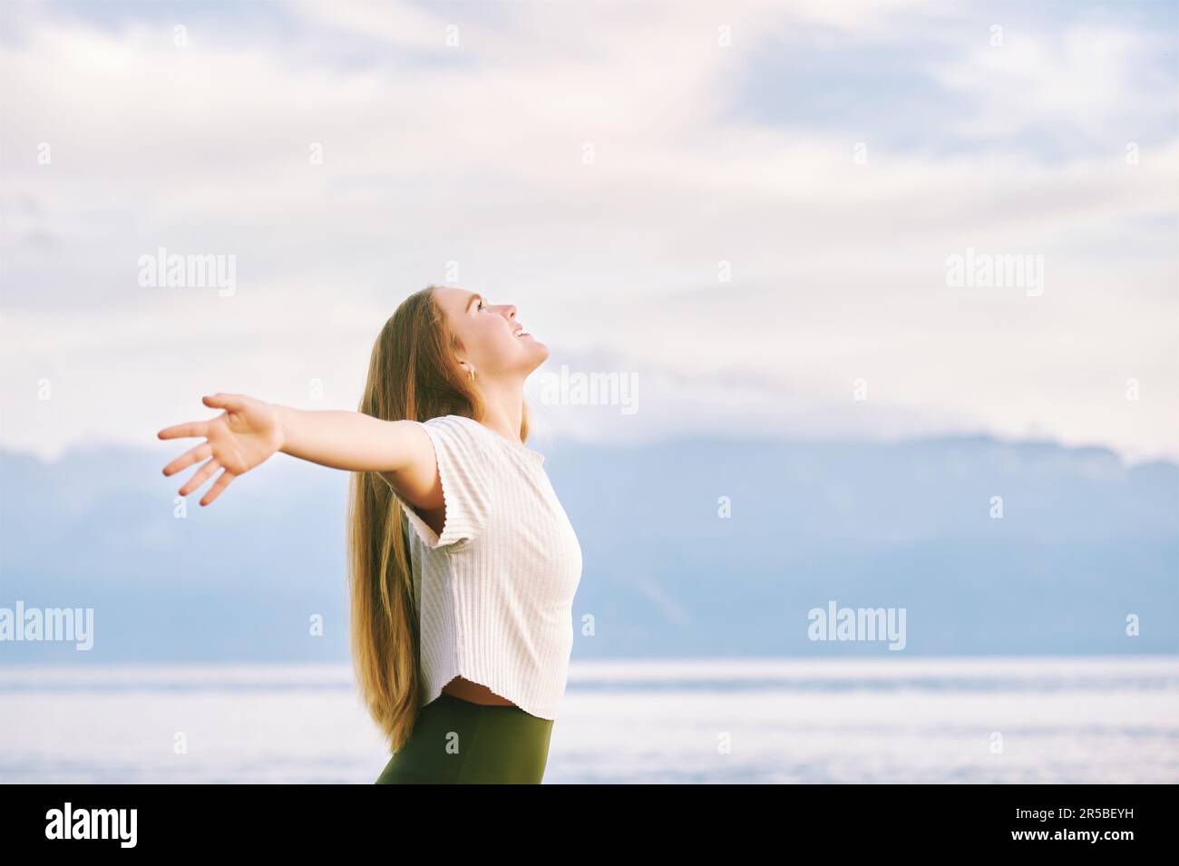 Outdoor portrait of beautiful young woman enjoying nice sunny day by ...