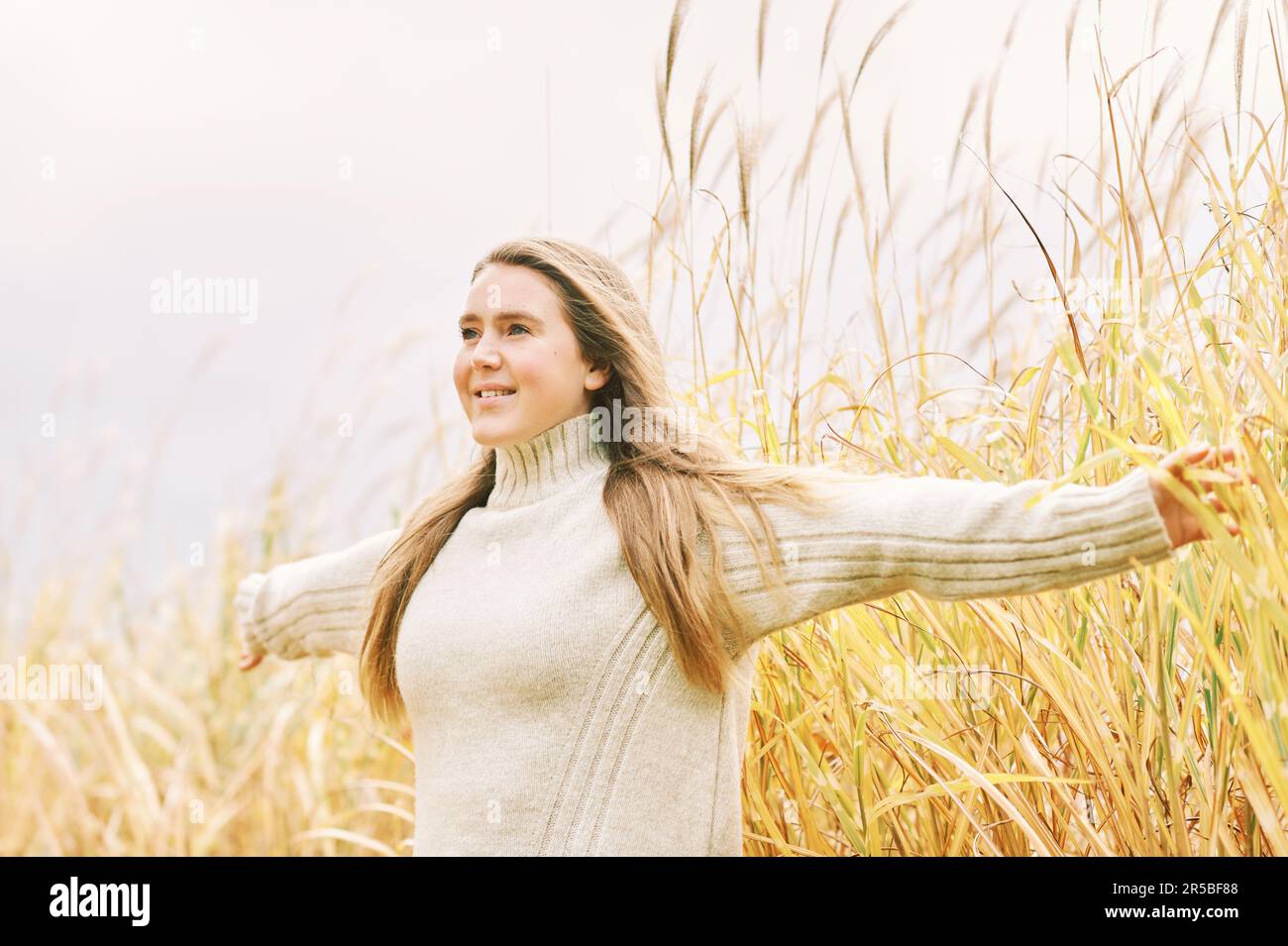 Fall Portrait Of Young Pretty Girl Posing Outside With Pampas Grass