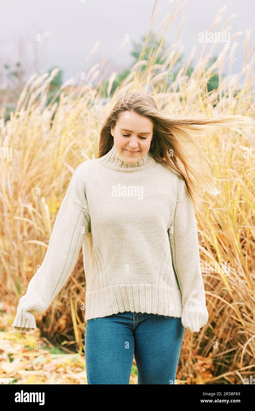 Fall portrait of young pretty girl posing outside with pampas grass ...