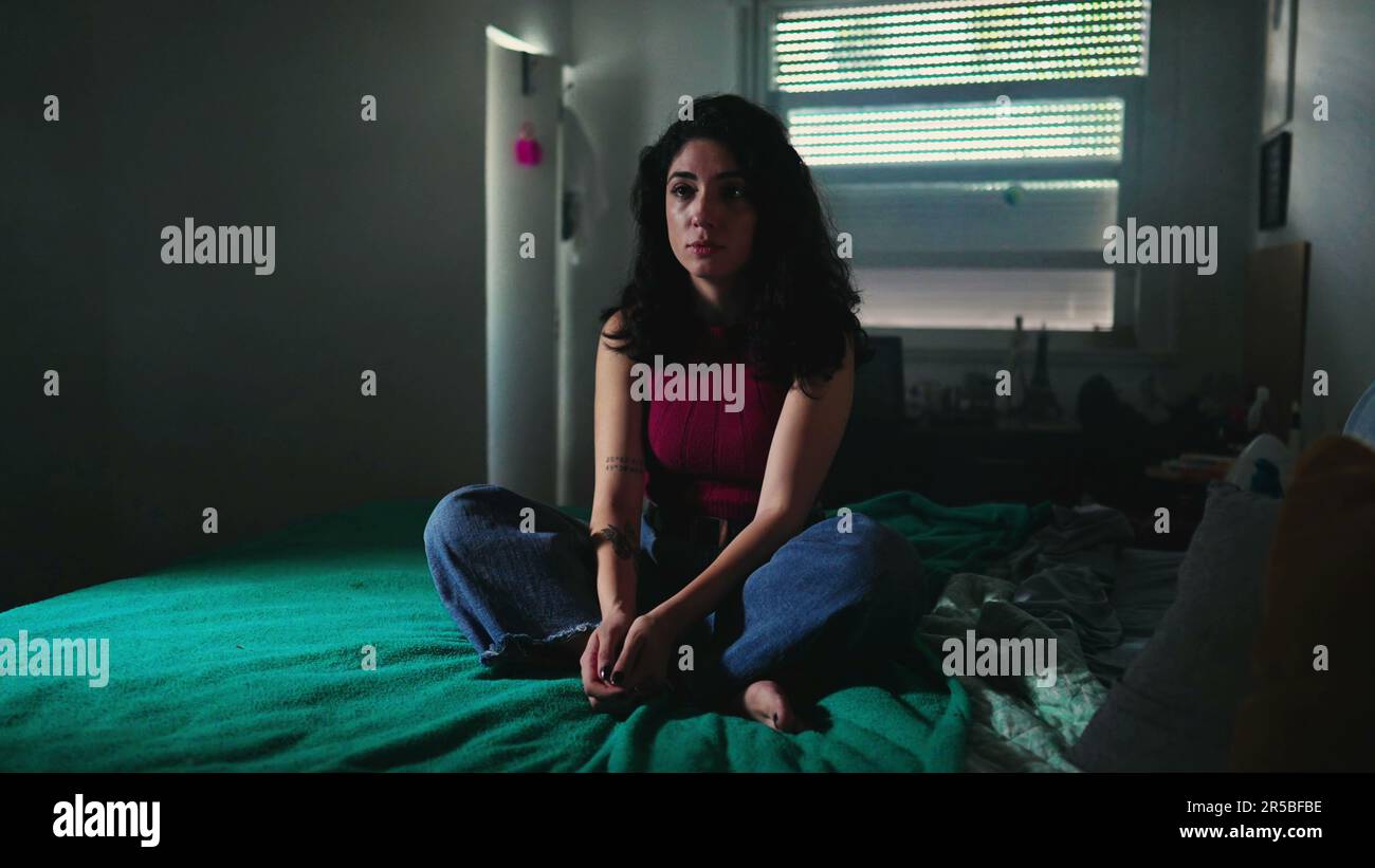 Loneliness Young Woman in Solitude inside a Somber bedroom, Her ...