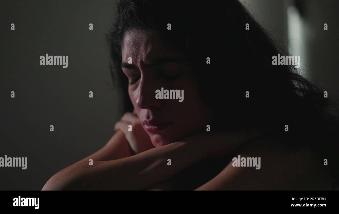 Fragile young woman struggling with mental illness in dar room. Female ...