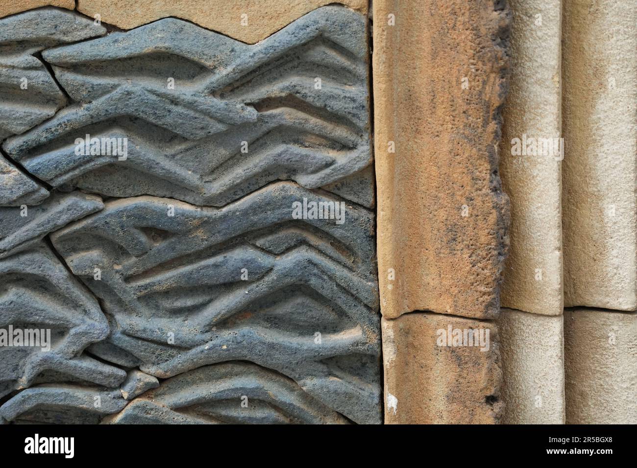An old and historic stone wall with intricate carvings adorning its ...