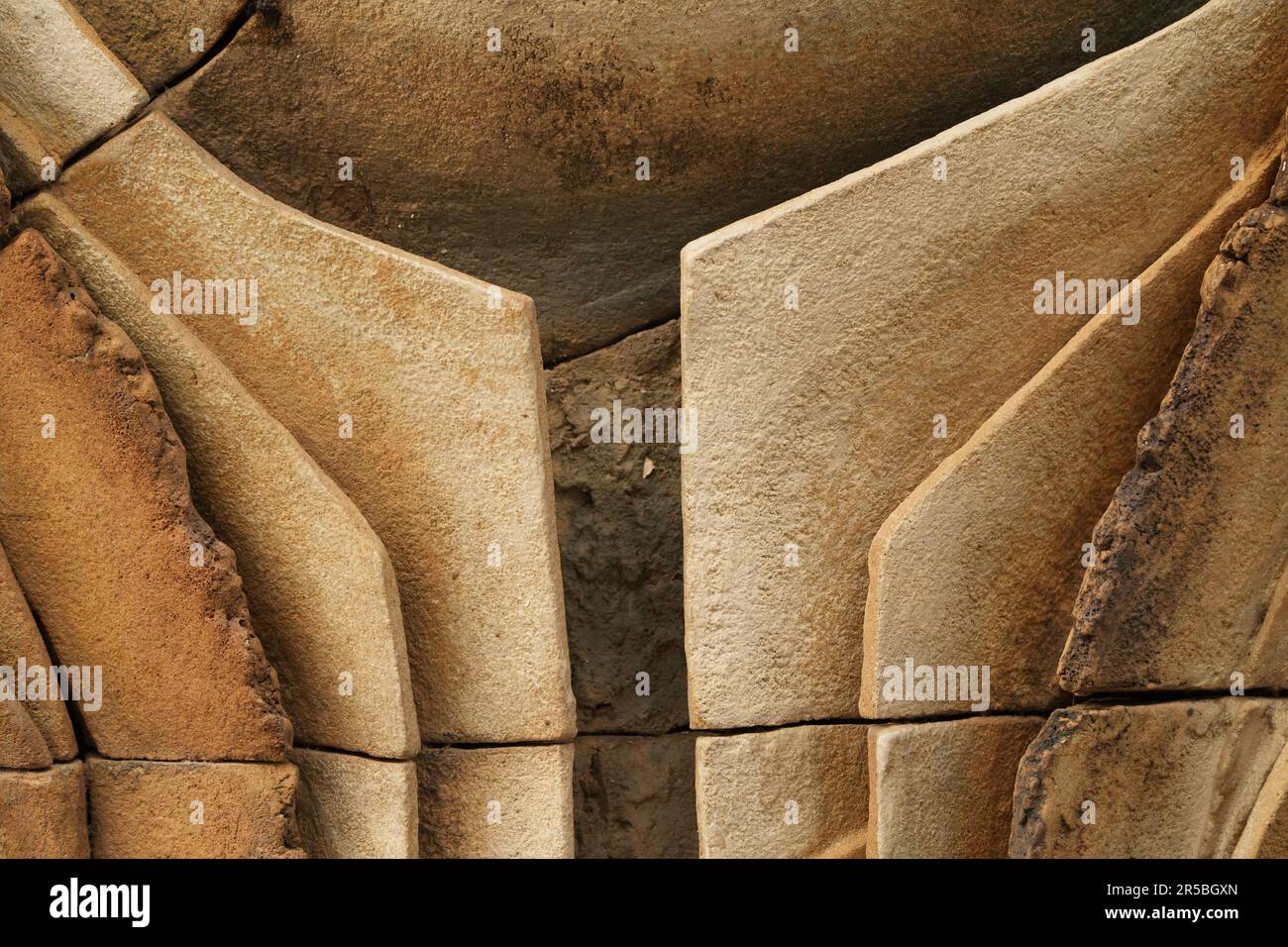 An old and historic stone wall with intricate carvings adorning its ...