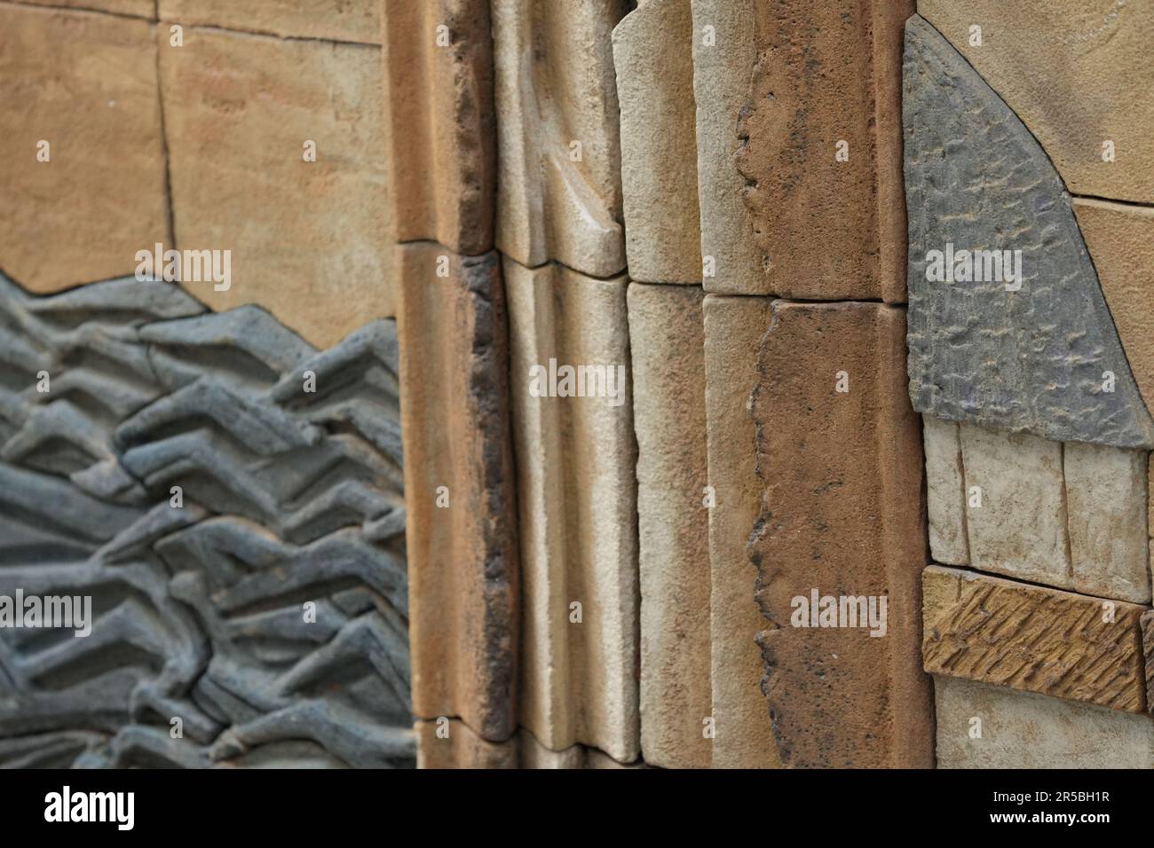 An old and historic stone wall with intricate carvings adorning its ...