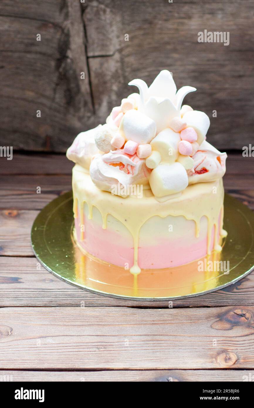 Tender pink birthday cake with melted white chocolate, fondant crown ...