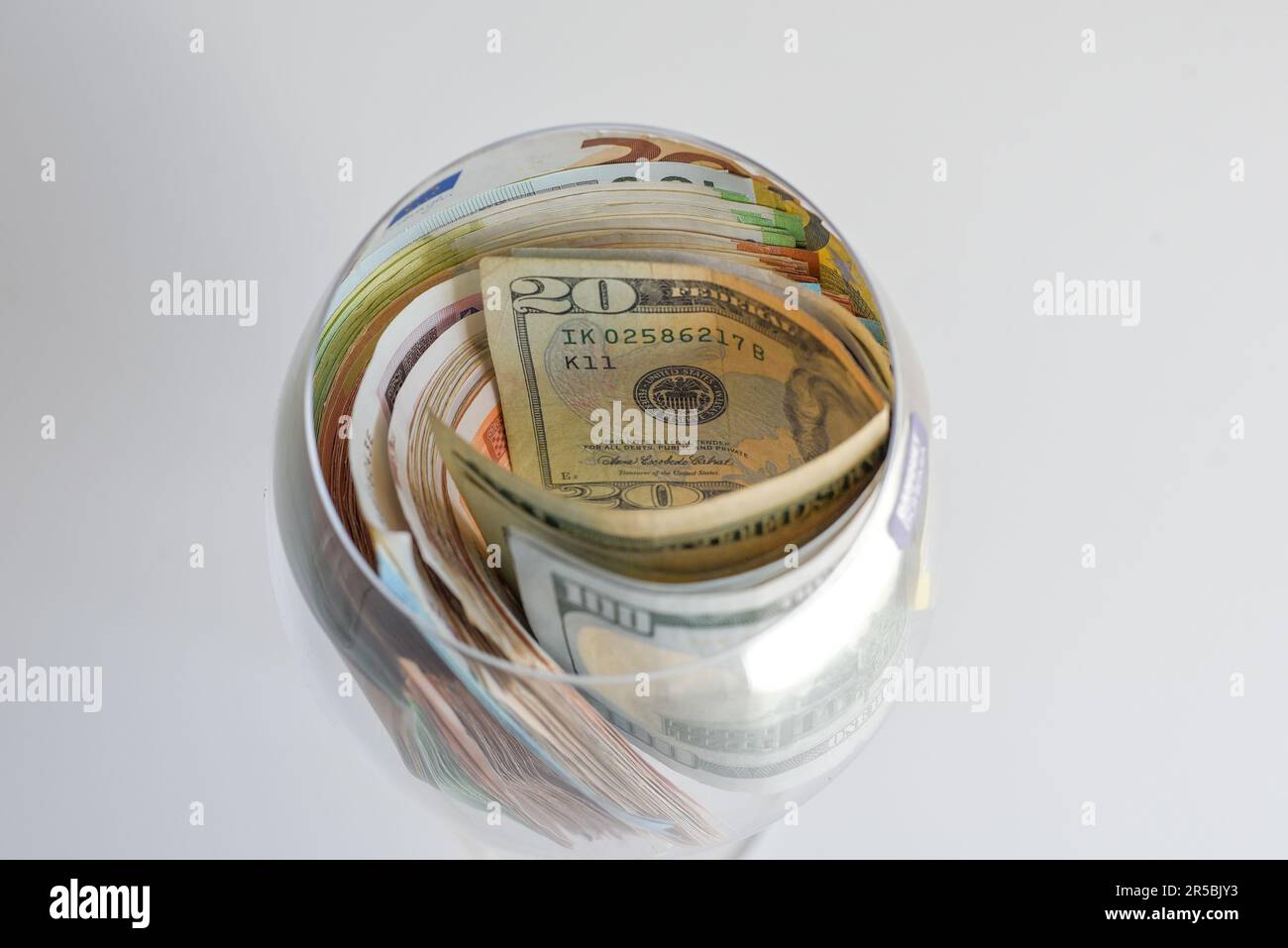 A close up of a cup filled with different money bills Stock Photo - Alamy