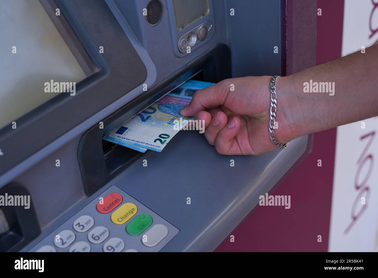 Taking money out of an atm hi-res stock photography and images - Alamy