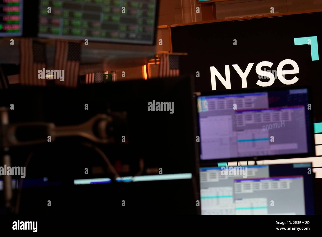 A screen displays the NYSE logo on the floor at the New York Stock ...