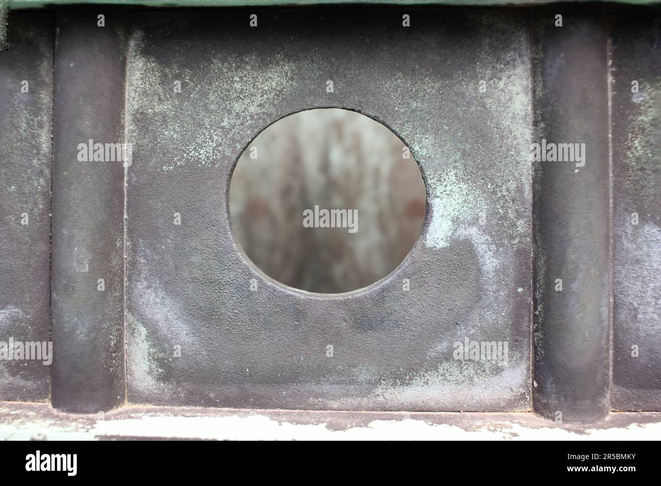 A circular hole carved into a copper metal wall Stock Photo - Alamy
