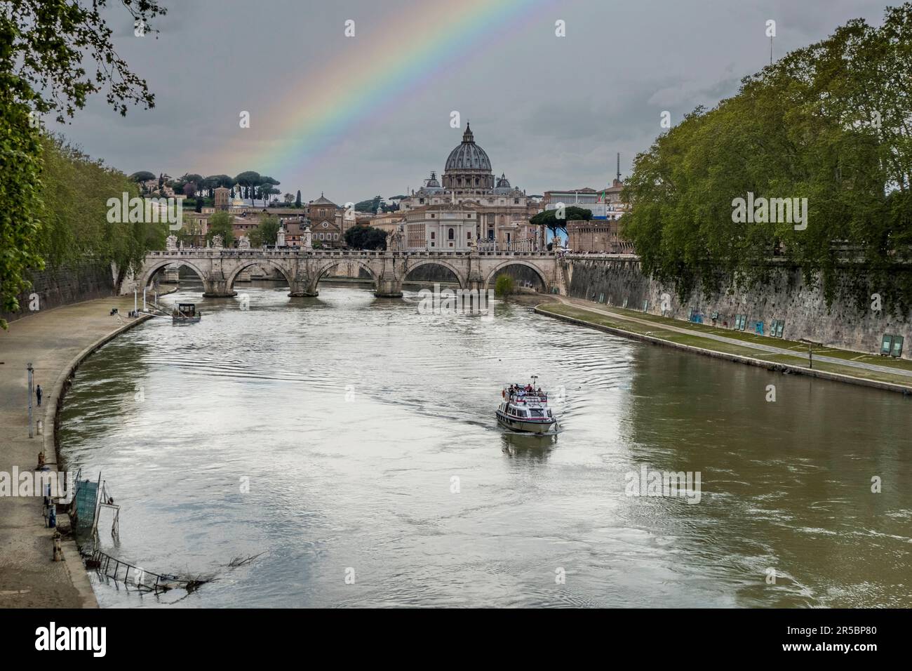 The Tevere river with a rainbow over the dome of the Basilica of San ...