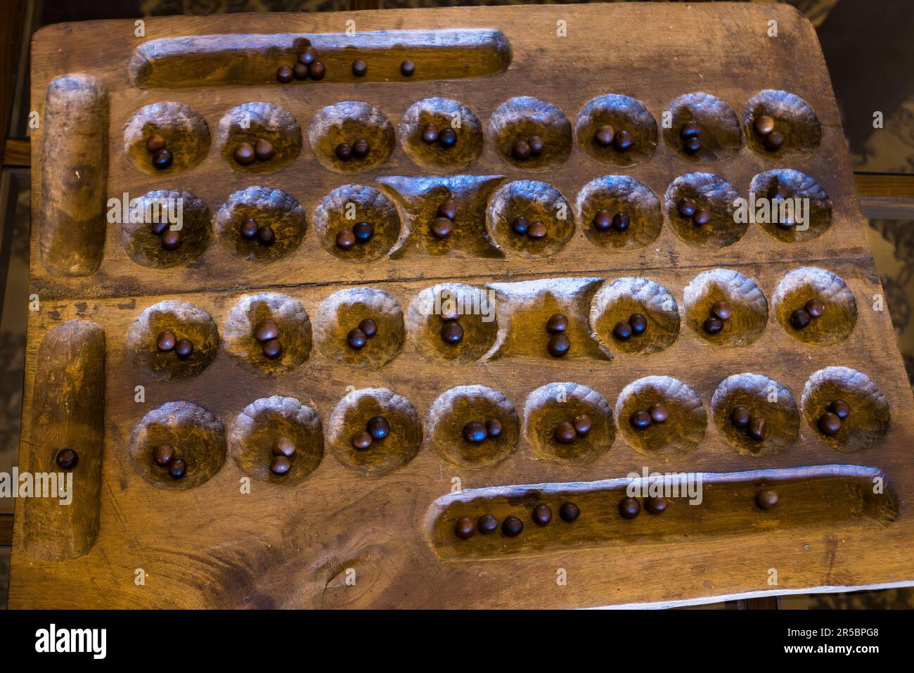 Old baobab game with tea seeds as tokens in the lobby of Huntingdon ...