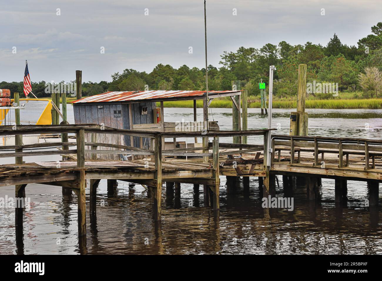An old wooden dock with the American Flag on the intercostal waterways ...