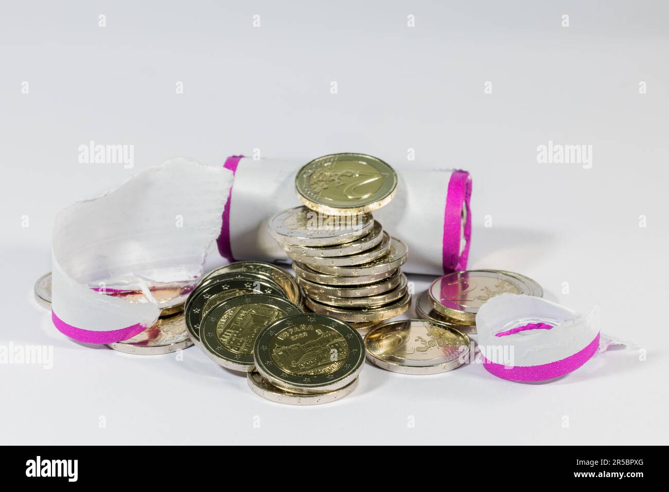 A close-up of two Spanish euro coins placed atop each other on a plain ...