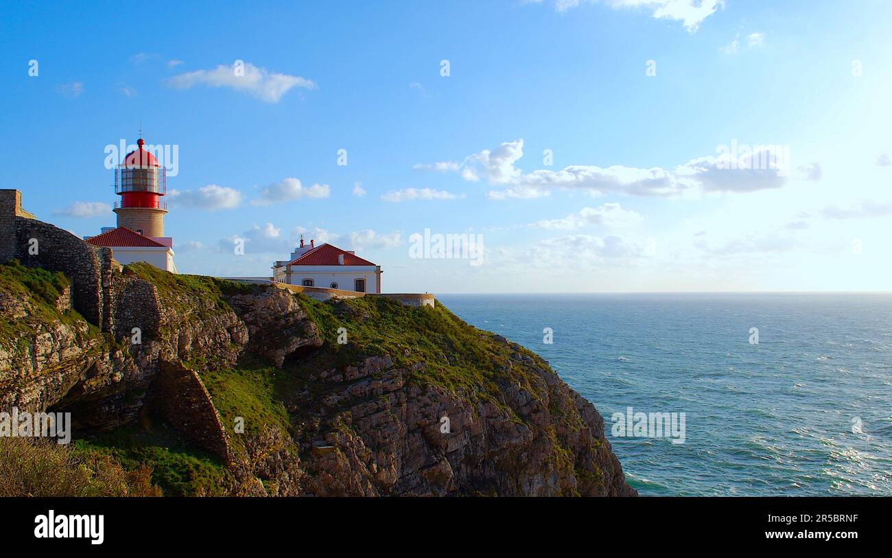 A beautiful lighthouse perched atop a rocky, cliffside overlooking the ...