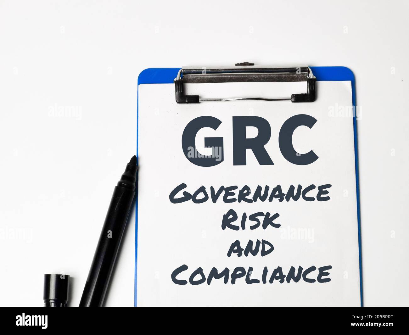 GRC Governance Risk and Compliance concept written on paper clipboard ...