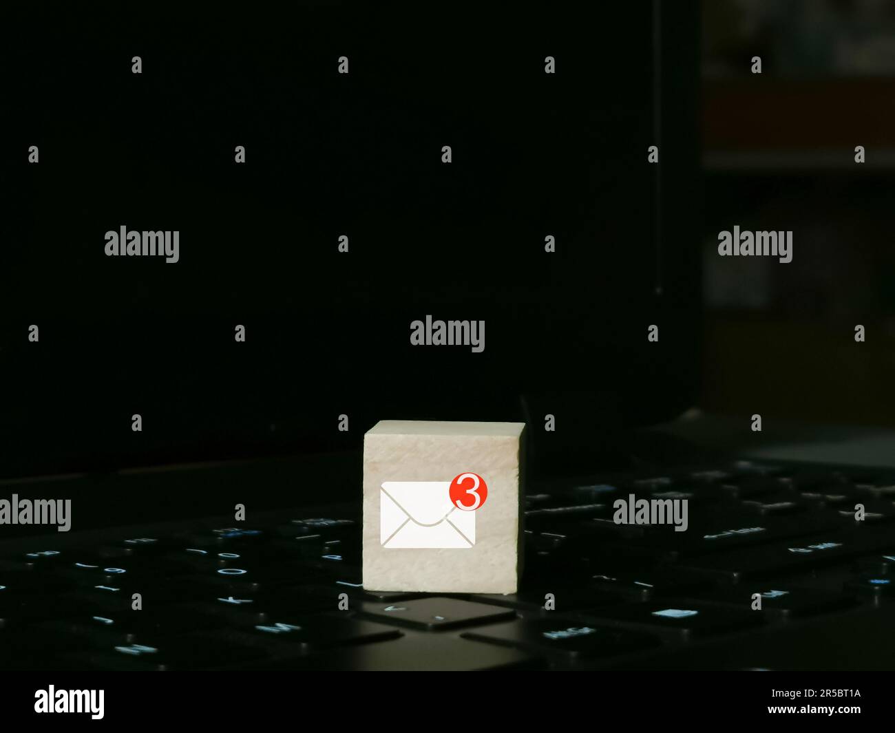 A wooden block with an email icon set ona black computer keyboard Stock ...