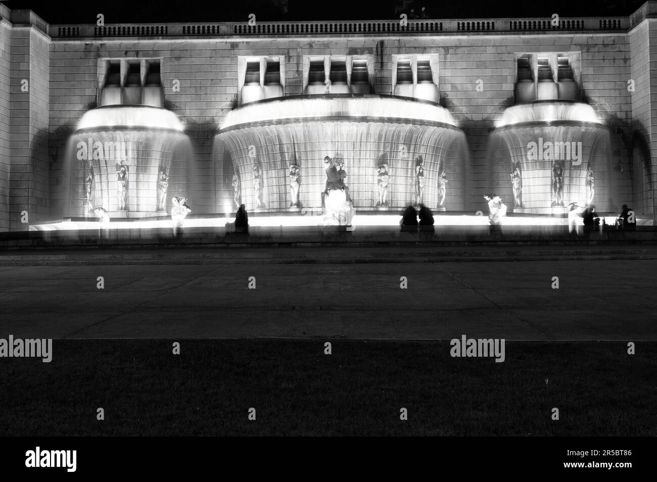 A vertical skyscraper structure illuminated by bright lighting fixtures ...