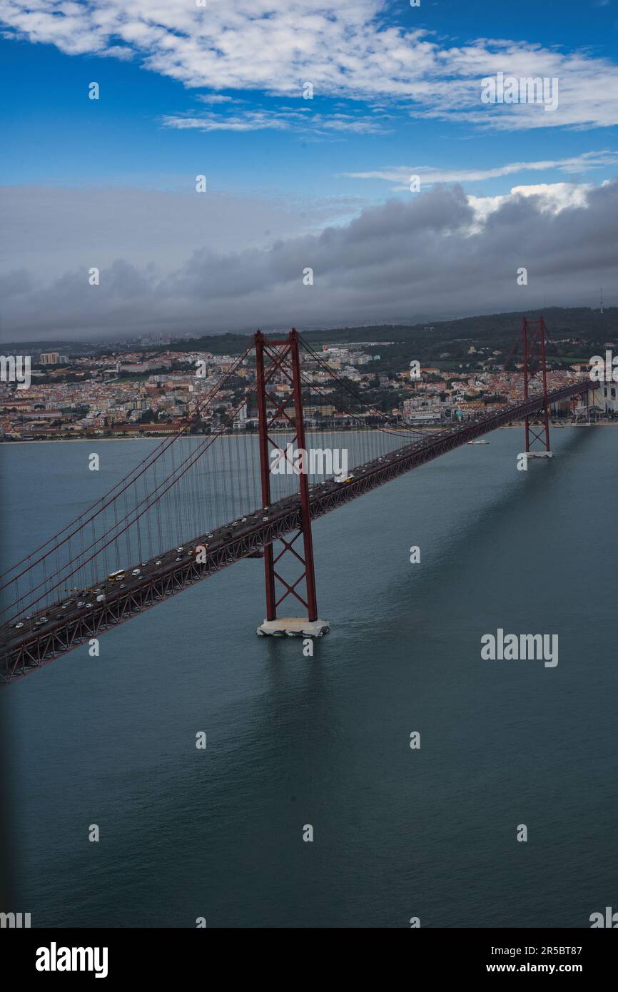 Aerial view of a bridge with white billowing clouds in the background ...