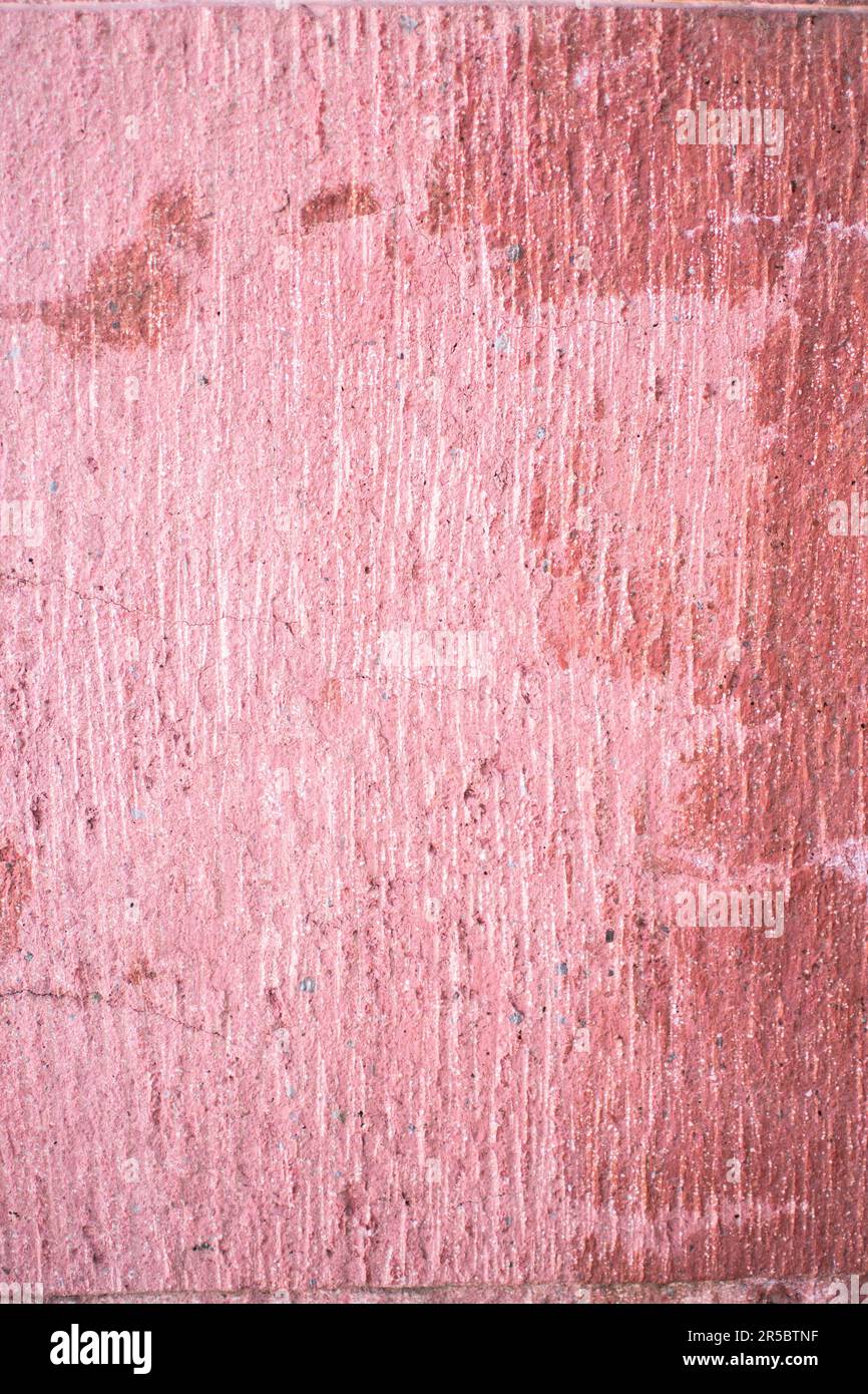 This is an image of a stone wall with visible stains from paint, giving ...