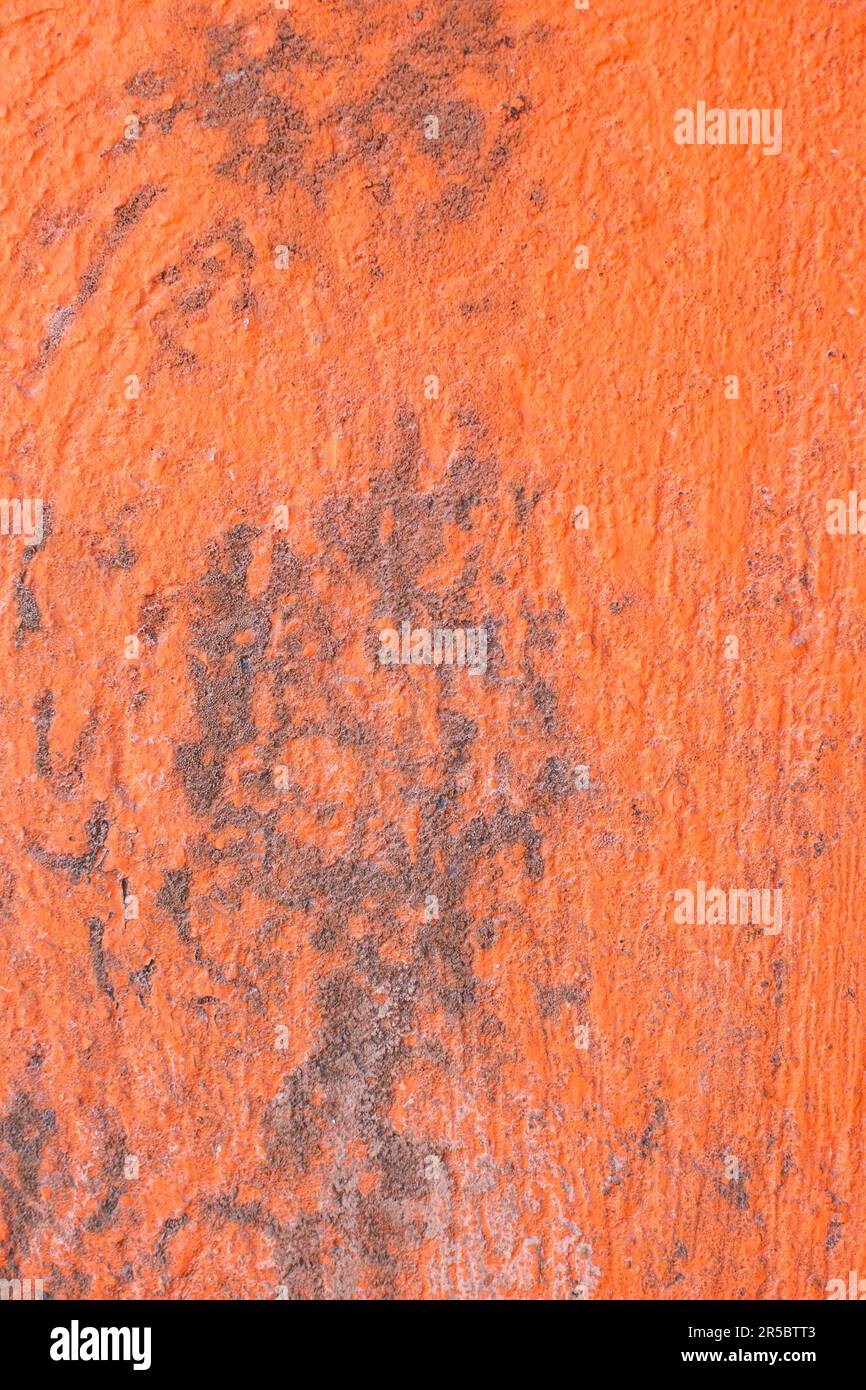 This image features a wall with a staining of dark red color, likely ...