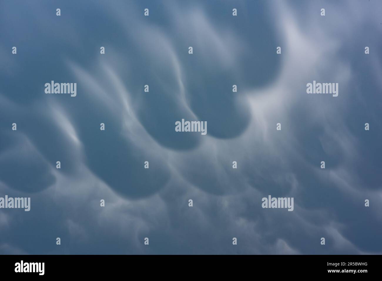 A dramatic cloudy sky with a plethora of thick clouds that appear to be ...