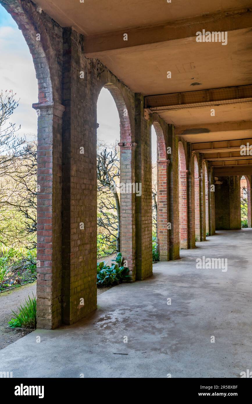 A colonnade of brick arches in a park Stock Photo - Alamy