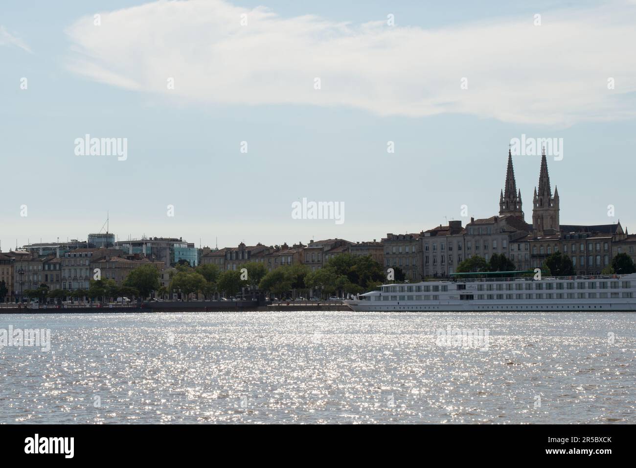 A large boat on the river with gothic architecture in the background on ...
