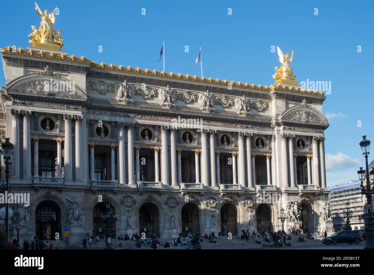 The Palais Garnier opera house in Paris, France with people nearby ...