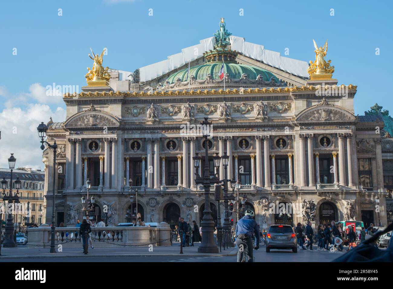 The Palais Garnier opera house in Paris, France with people and cars ...