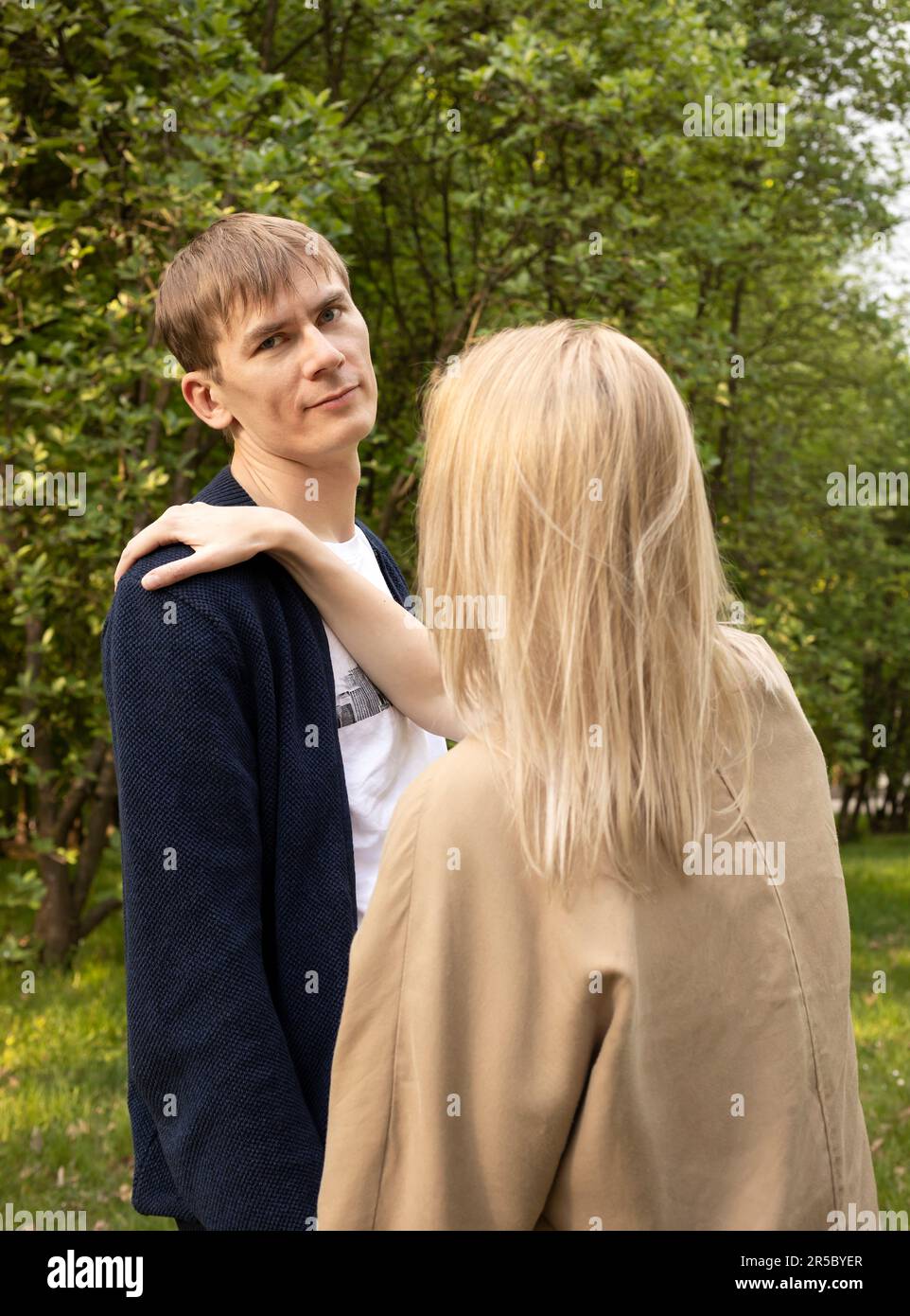 Couple In Park. Back View Of Woman Holding Hand On Man's Shoulder ...