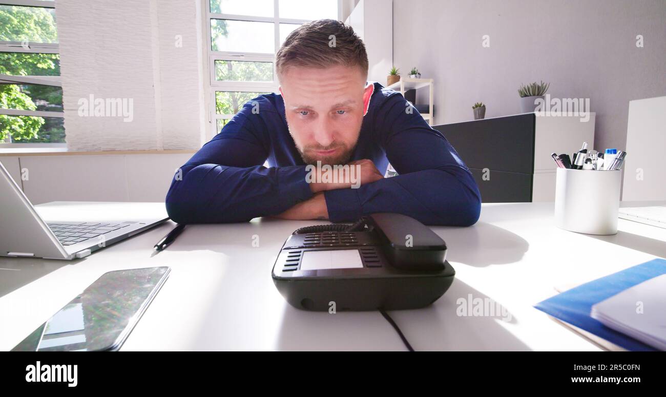Man Waiting Phone Call At Office Desk Stock Photo - Alamy