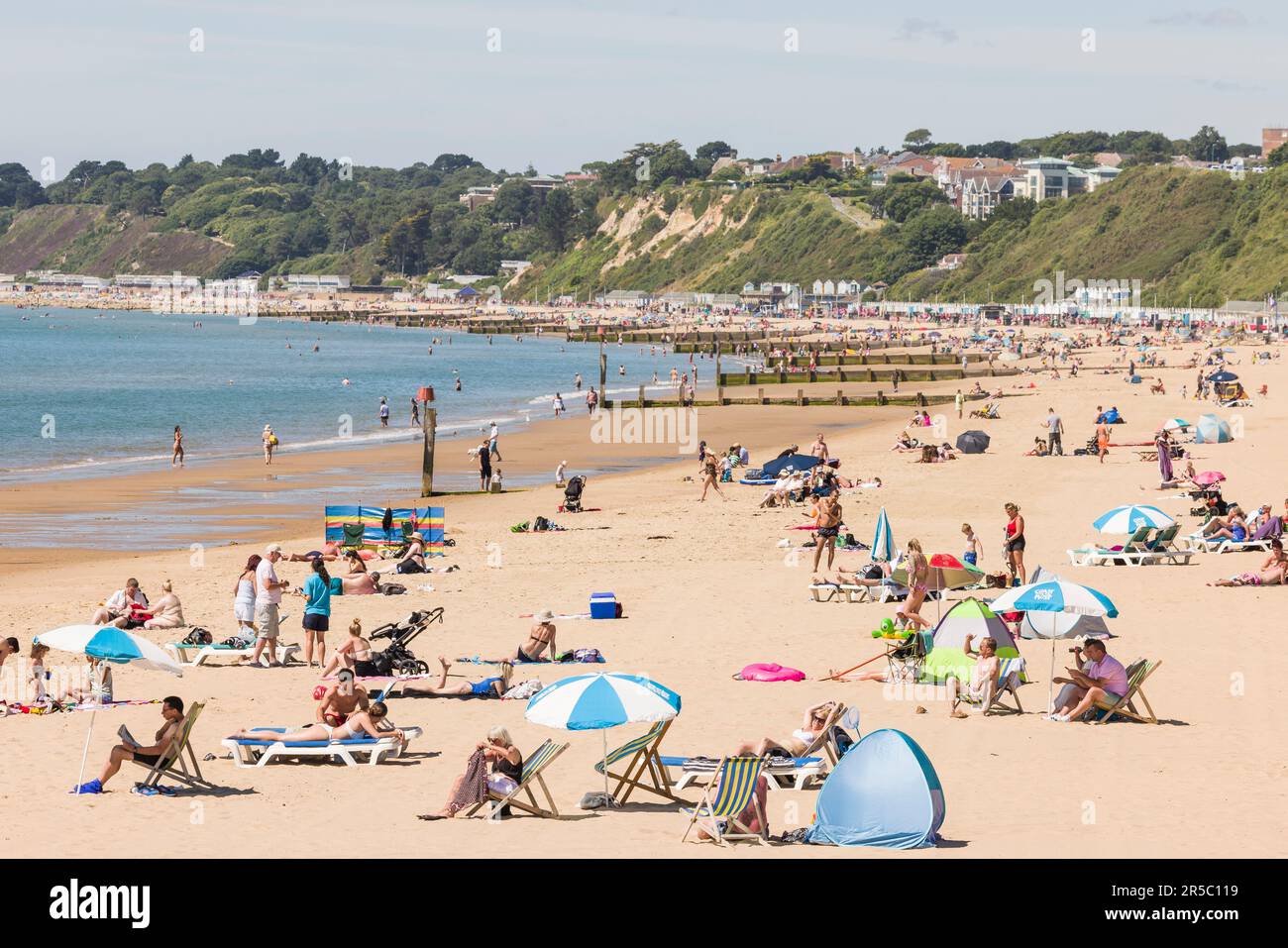 BOURNEMOUTH, UK - July 08, 2022. Sunbathers on a sandy beach in summer ...