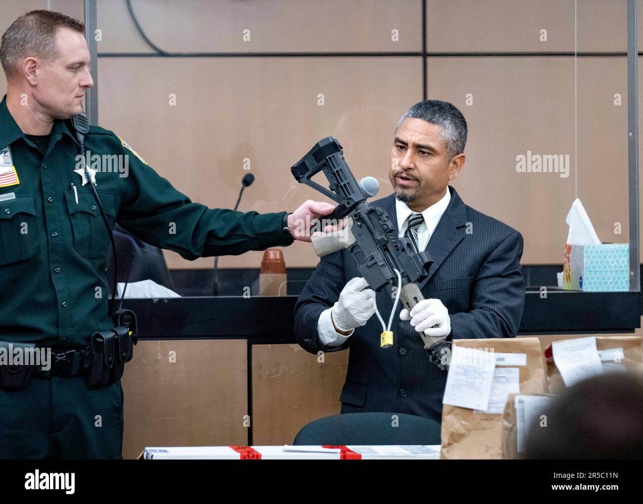 PBSO deputy Michael Lubinski holds the microphone for forensics ...