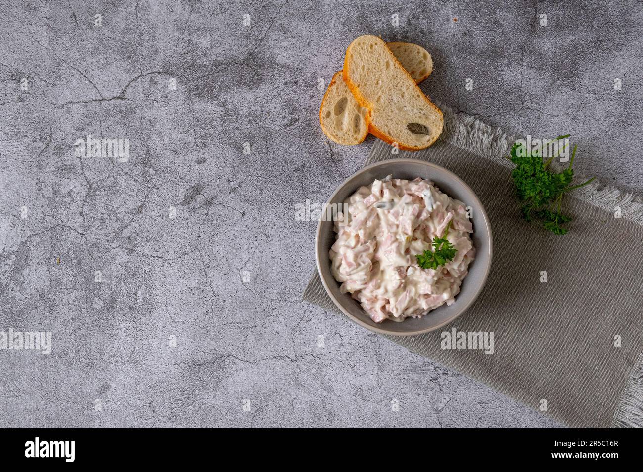 Meat salad with mayonnaise and cucumbersin a bowl. Udder salad Stock ...