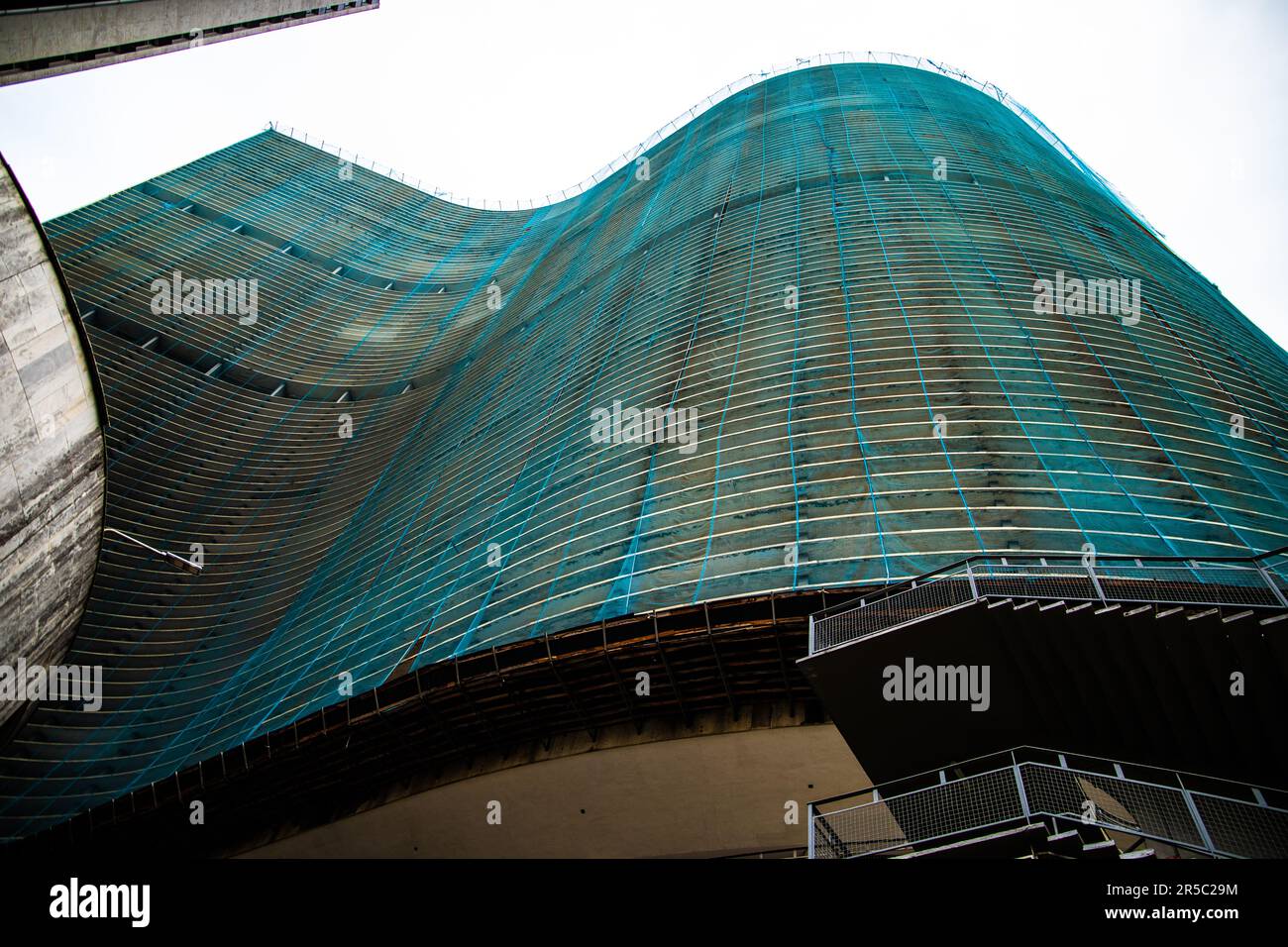 In the foreground of the image, a large construction building is seen ...