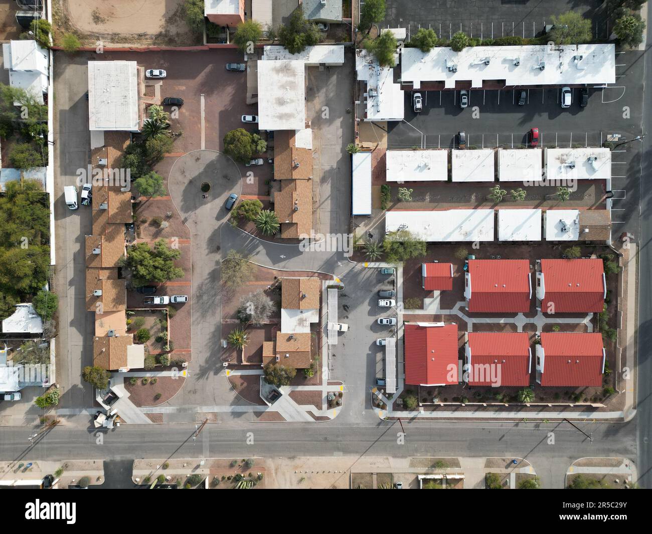 An aerial top view of a residential area with houses and parked cars ...