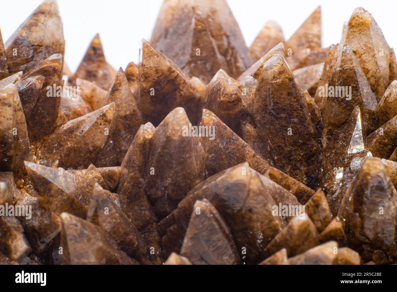 A high-resolution close-up image of a brown crystal with intricate ...
