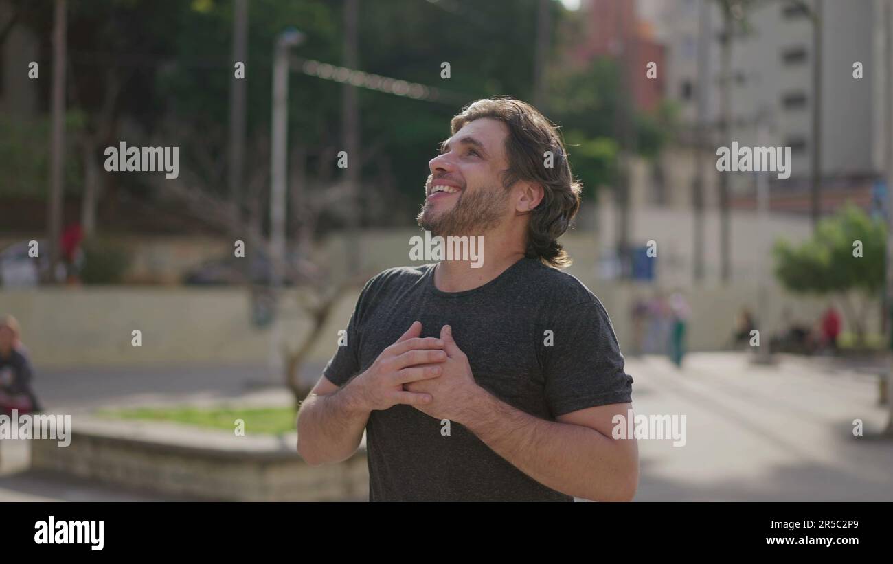 Thankful young man standing outdoors hi-res stock photography and ...