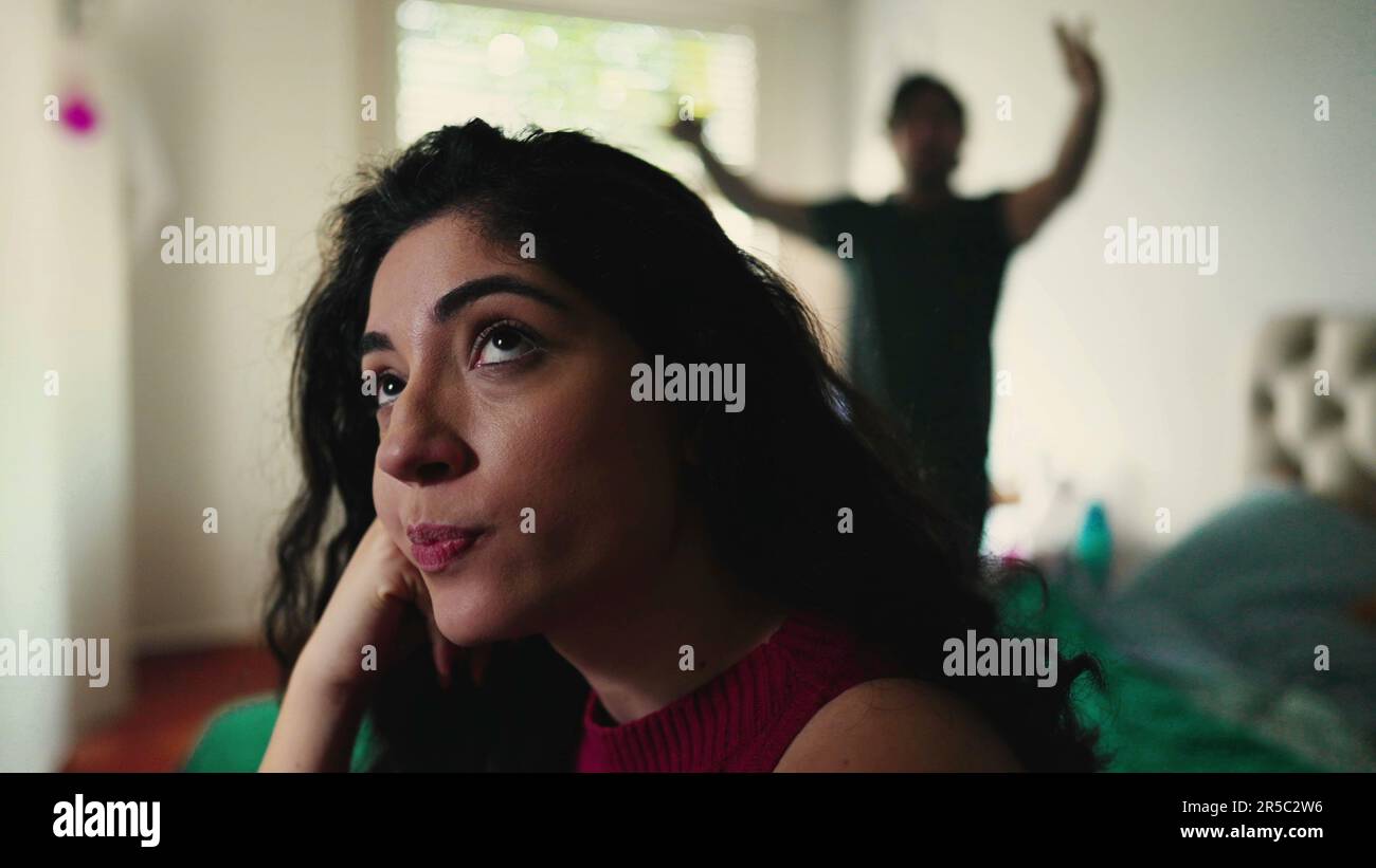 Wife Cynically Rolls Eyes as Husband Yells and Gestures in Background ...