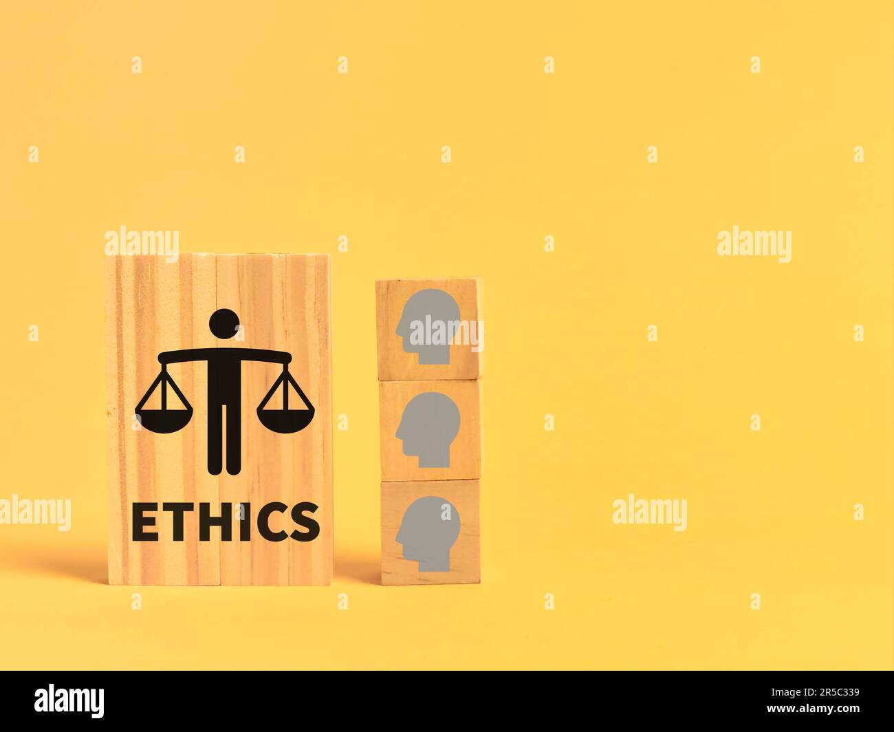 A wooden block with an illustration of a person with a scale and the ...