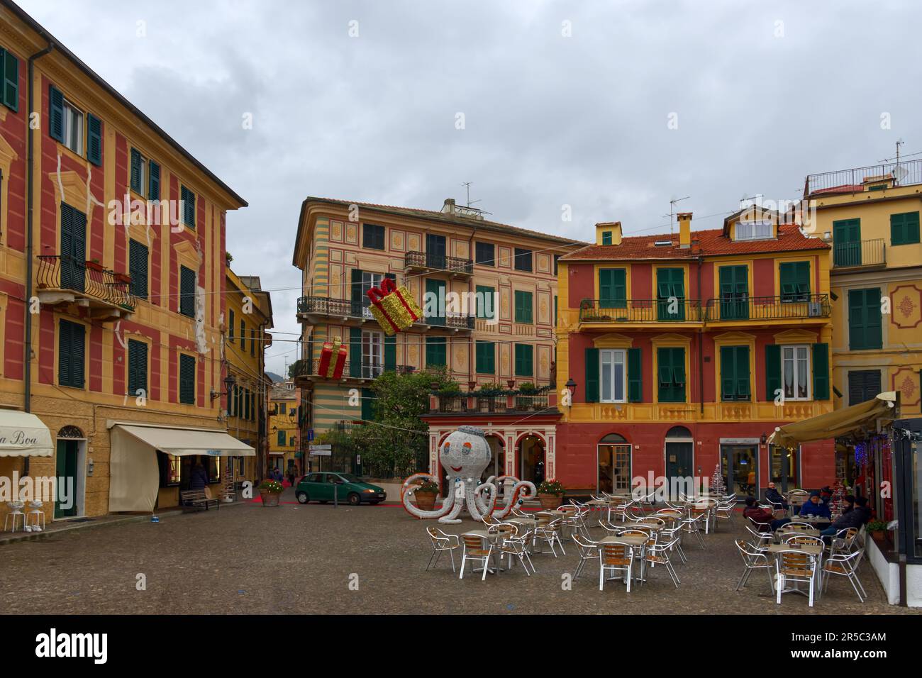 A sun-drenched courtyard with vibrant yellow and red buildings in the ...