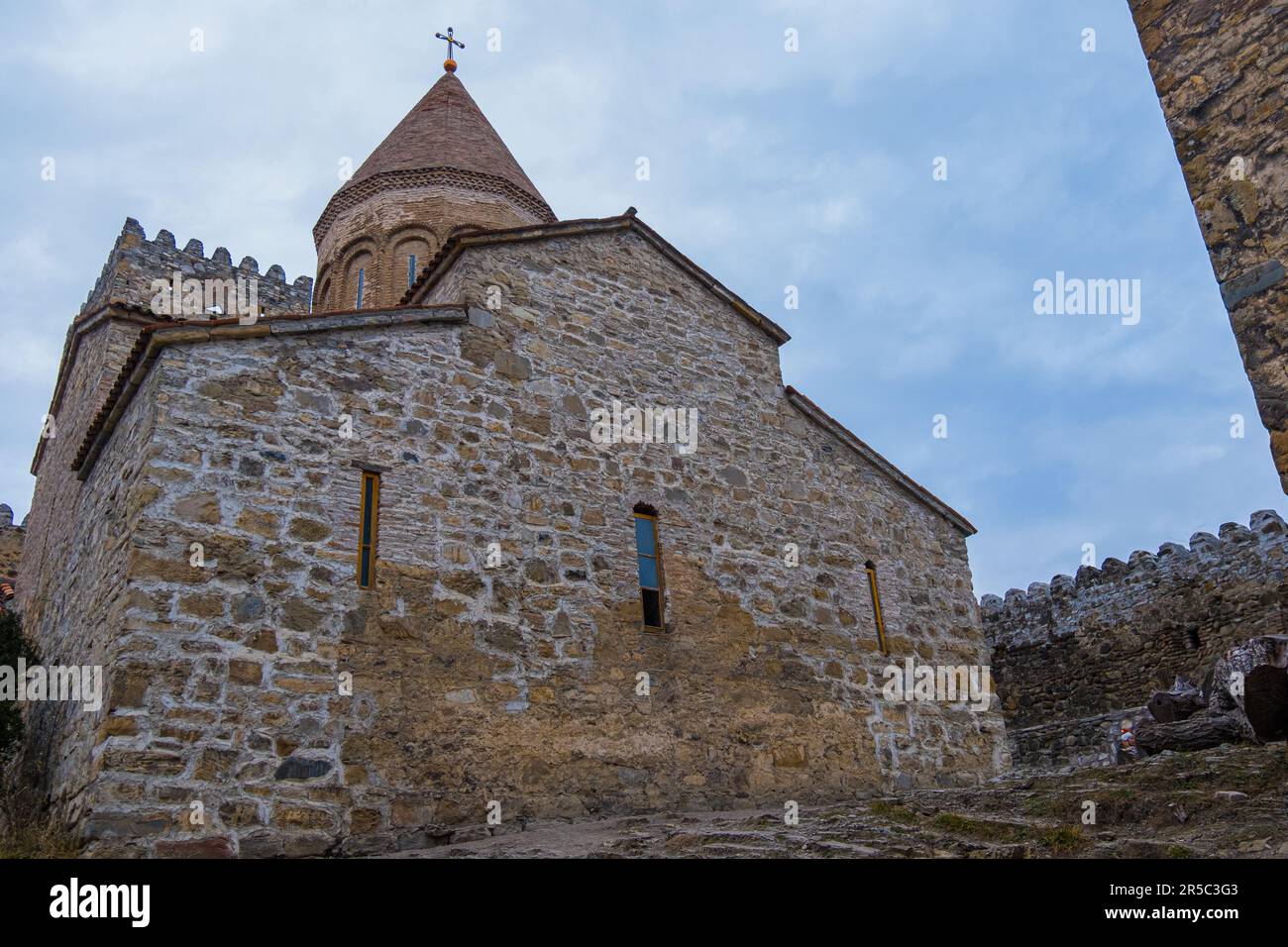 An ancient church surrounded by majestic stone structures stands ...