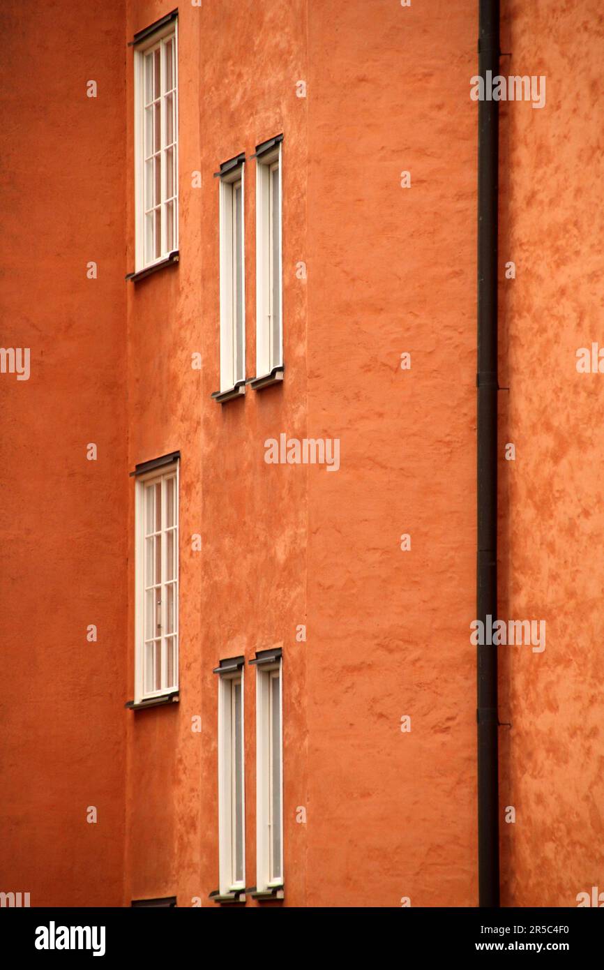 An orange colored residential building with white windows in Stockholm ...