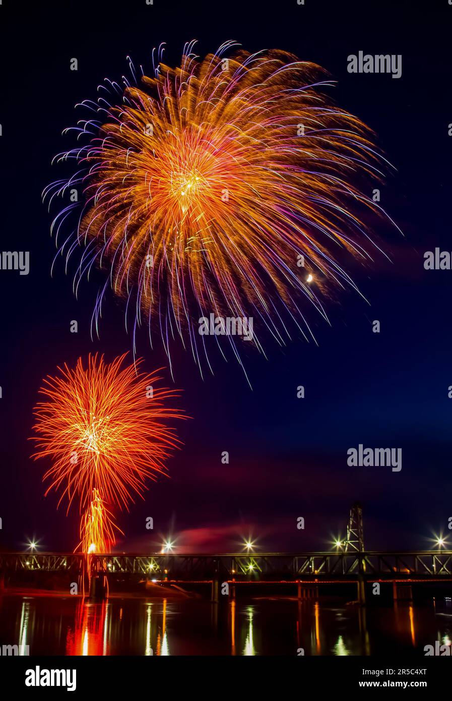The vibrant festive fireworks over the Meridian Highway Bridge at night ...