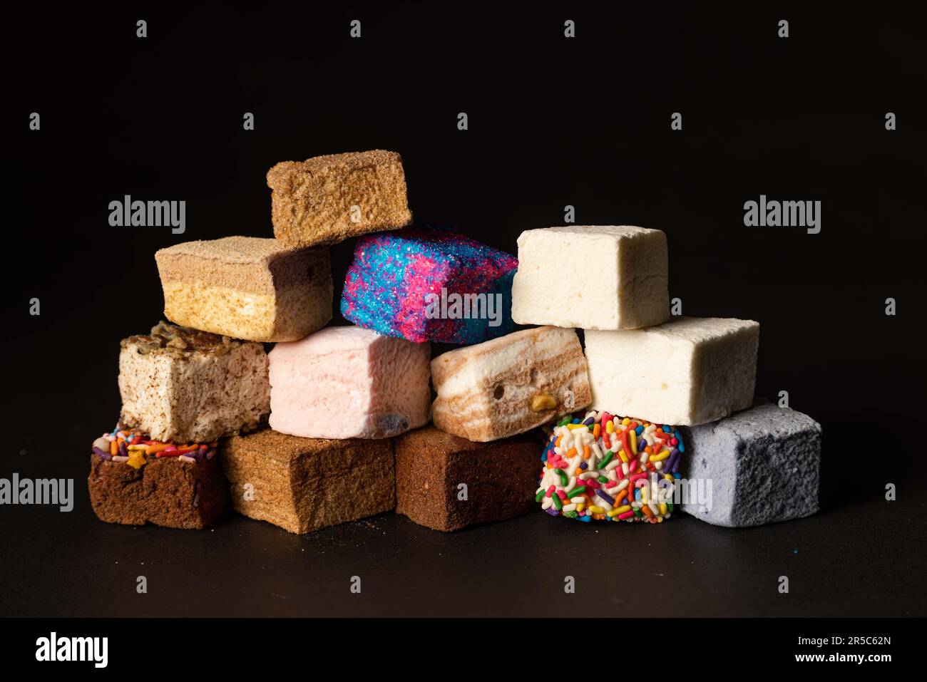 A close-up image of a white sugar cube, sprinkled with colorful ...