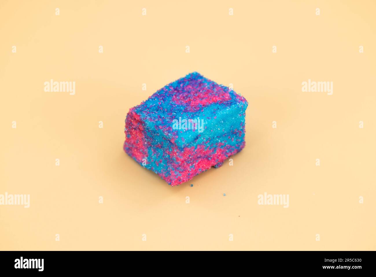 A delectable cake in shades of blue and pink, with a unique design that ...