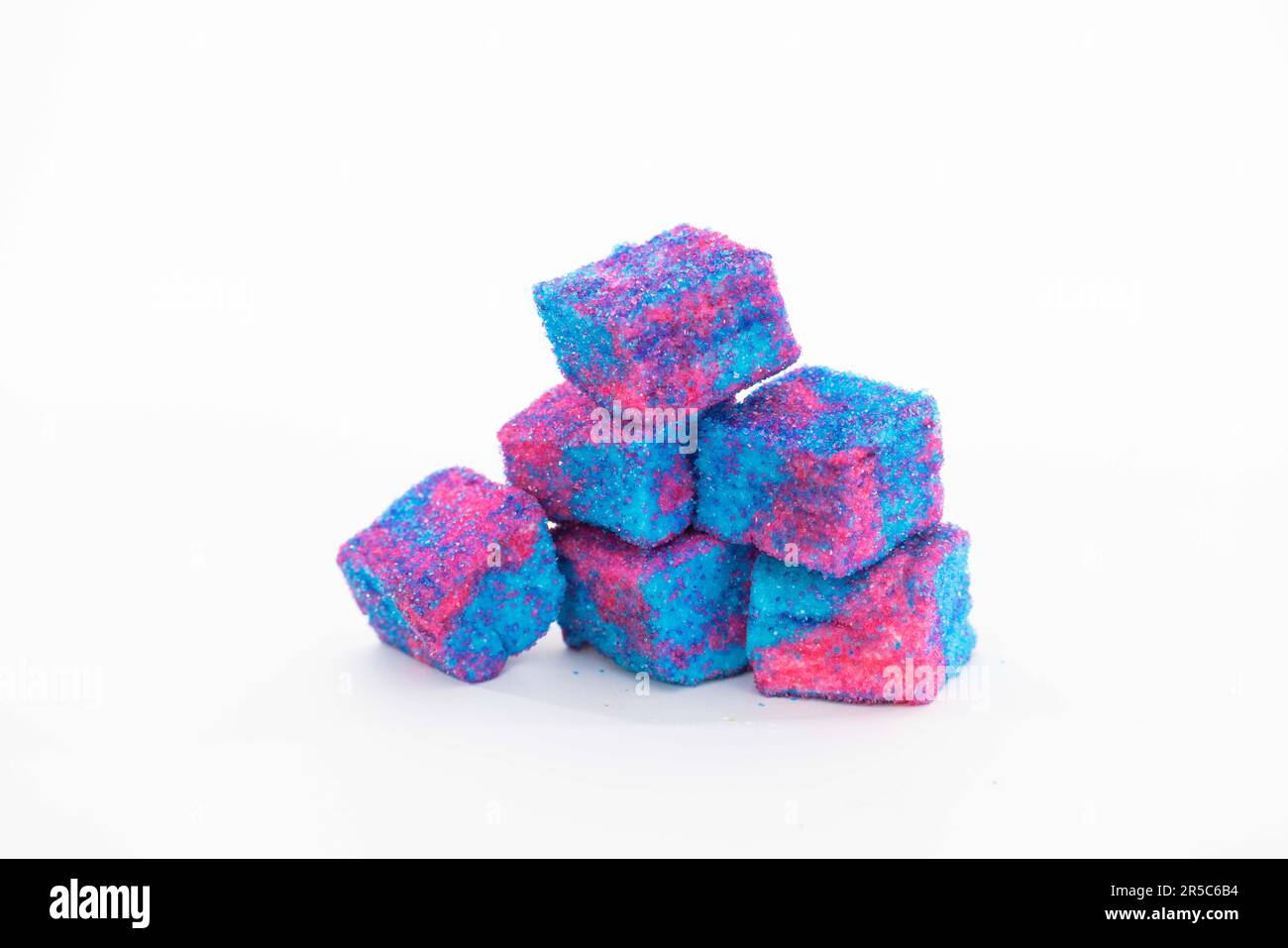 A vibrant display of multicolored sugar cubes arranged on a pristine ...