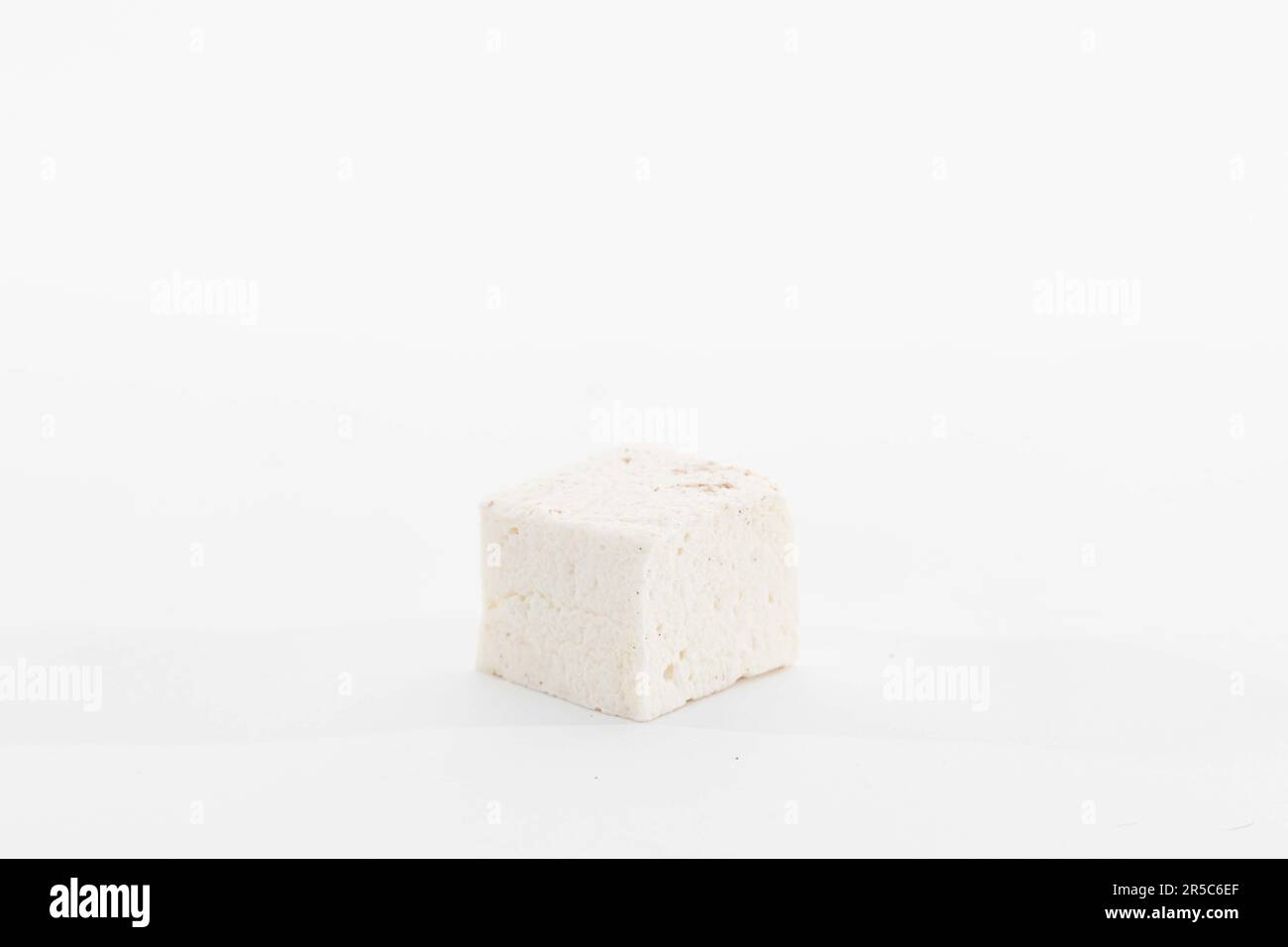 A close-up photograph of a white rectangular block of marshmallow is ...